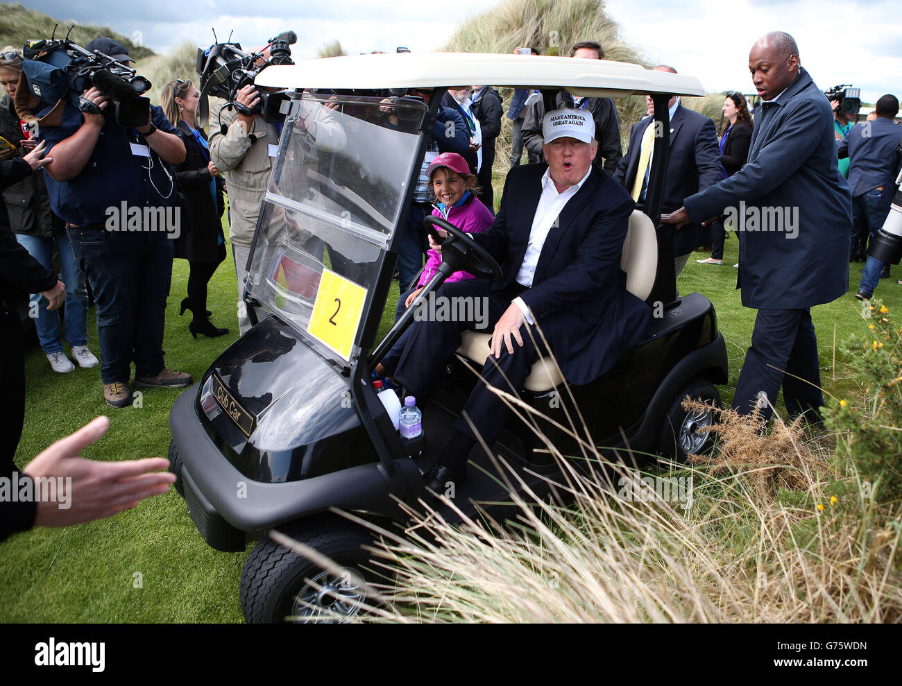 Donald Trump drives a golf cart with granddaughter Kai onboard after he ...