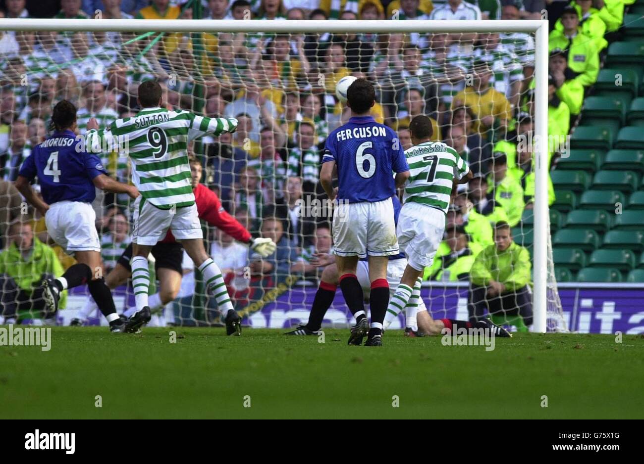 Celtic's Henrik Larsson (right) scores against Rangers during their ...