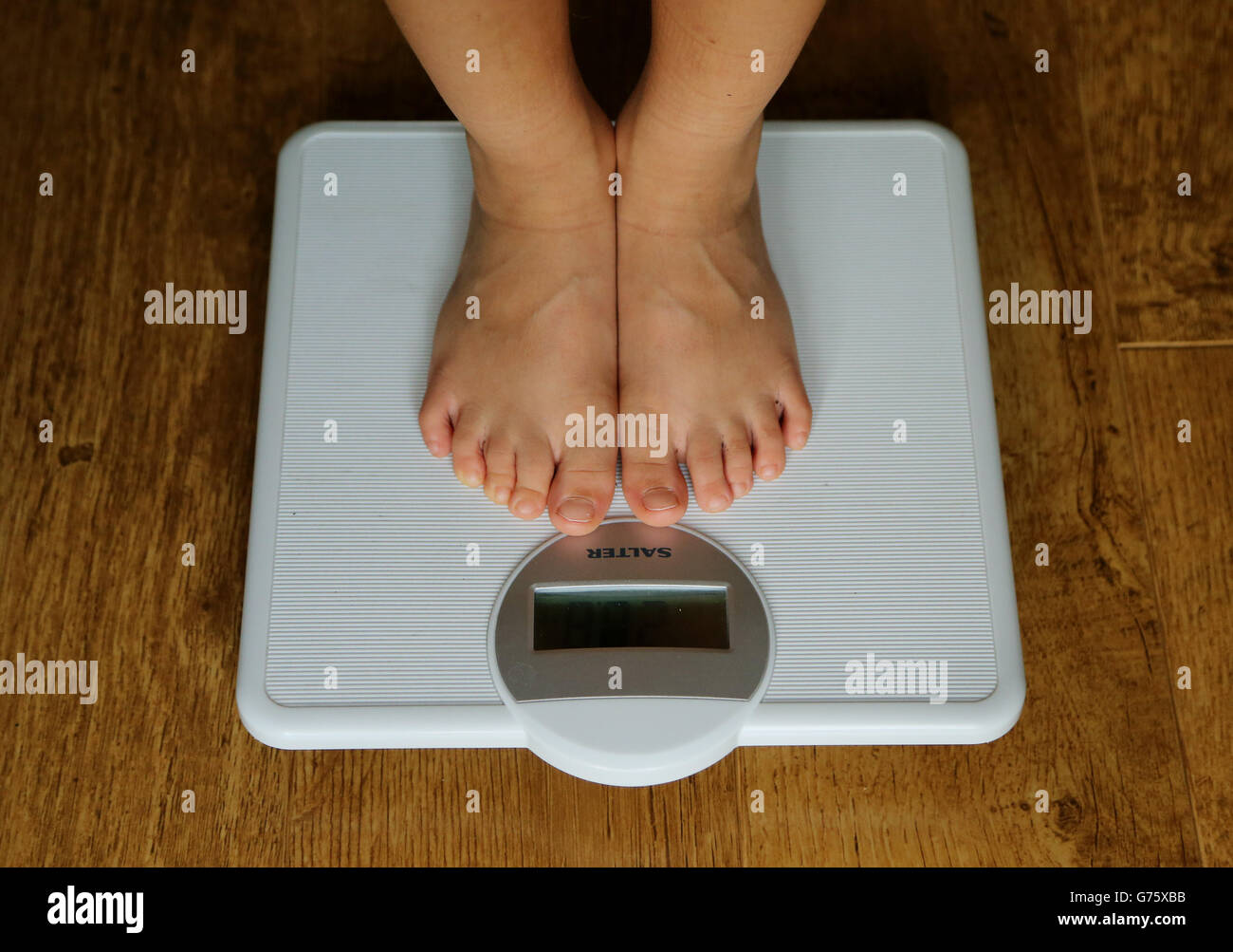 A young child is weighed on scales Stock Photo - Alamy