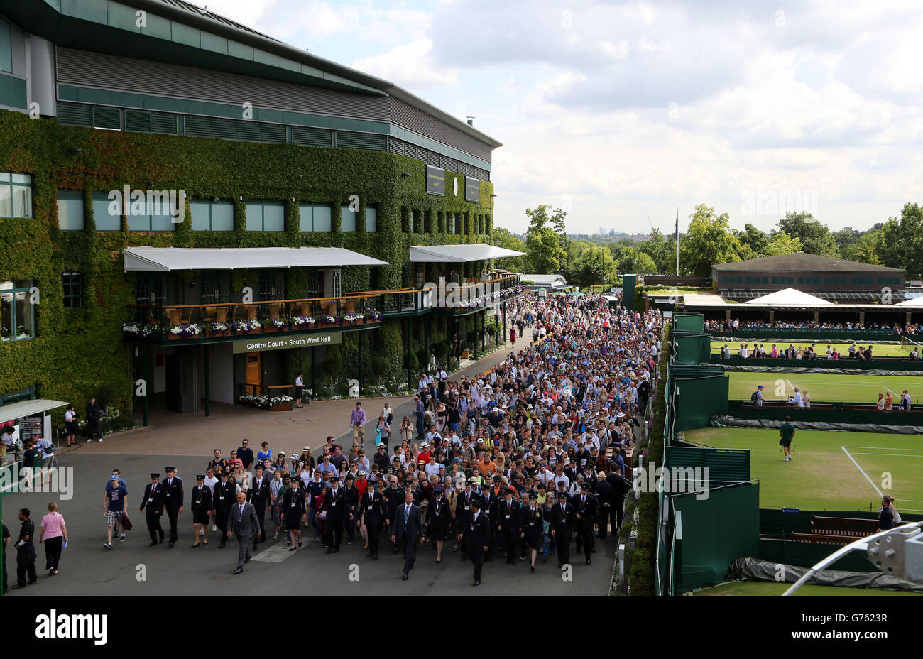 Security walk the crowd in past Centre Court during day eight of the ...