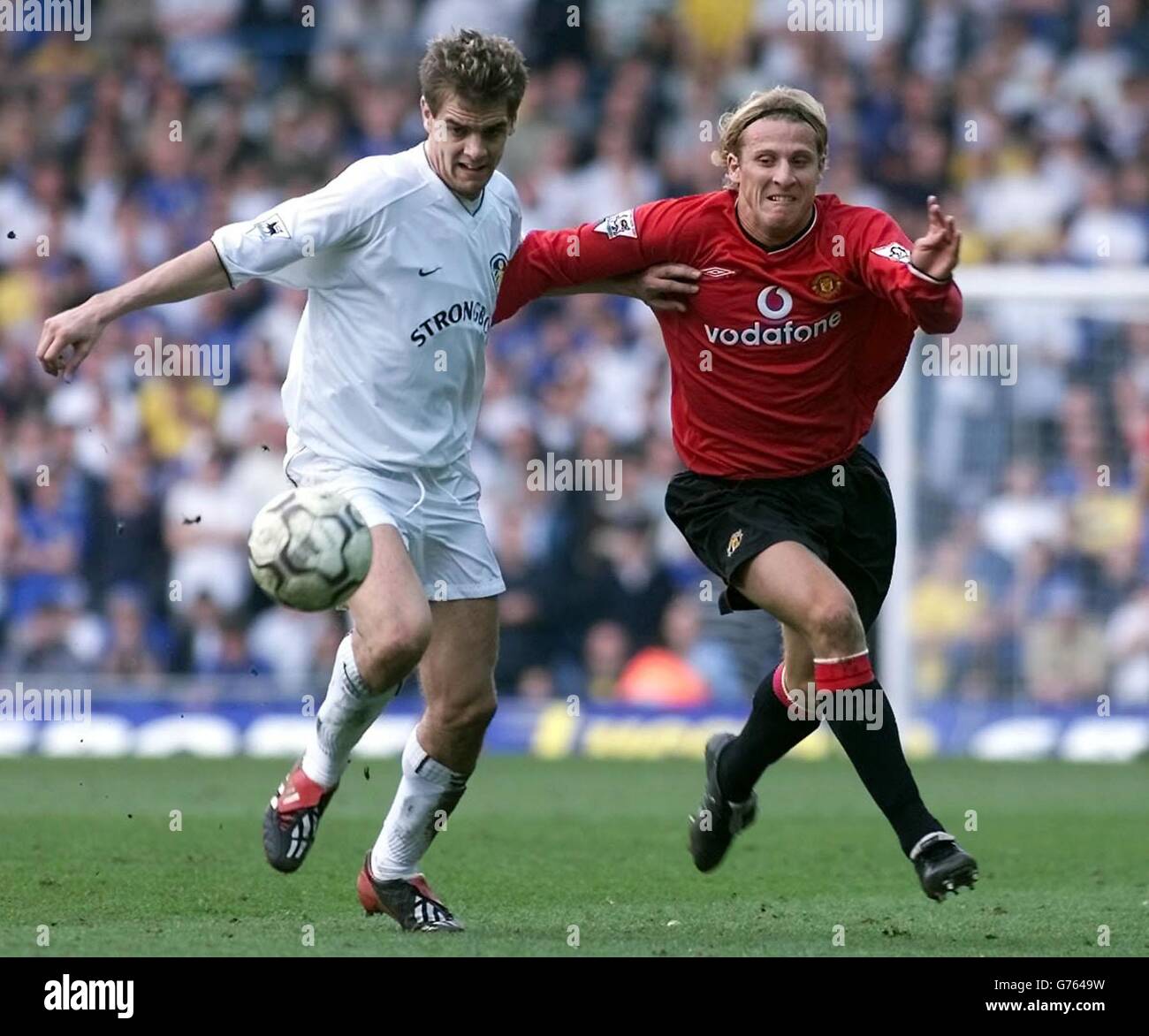 Leeds United's Jon Woodgate (left) holds back Manchester United's Diego ...