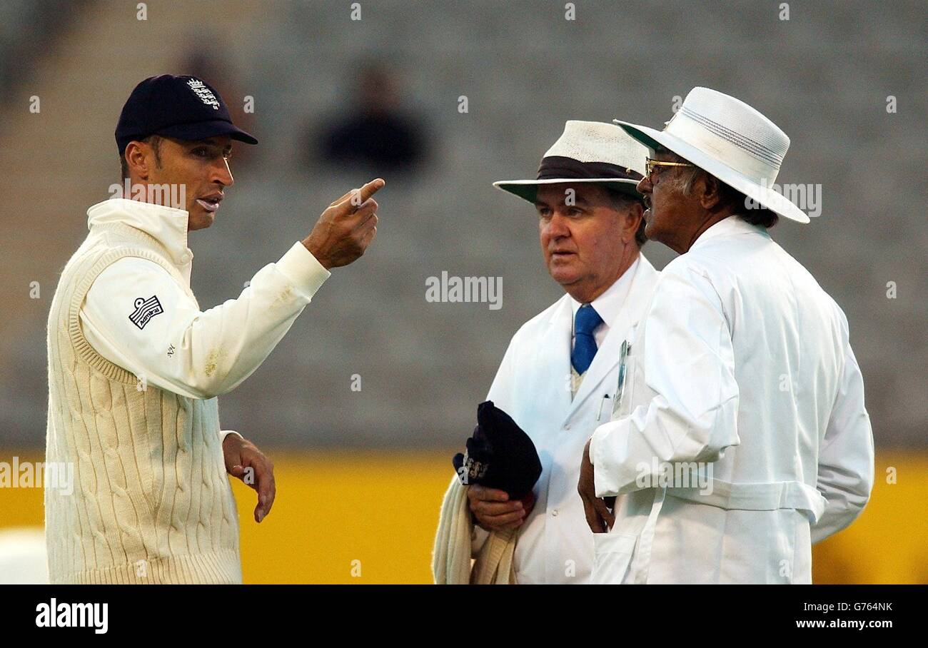 England skipper Nasser Hussain (left) speaks with umpires Doug Cowie ...