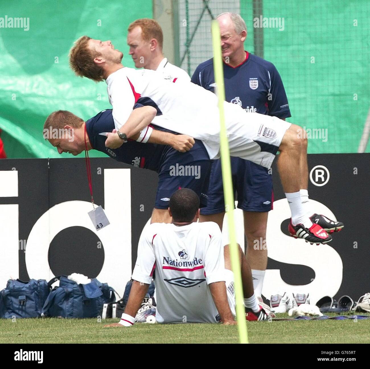 England's David Beckham is given a stretch by Gary Lewin during ...