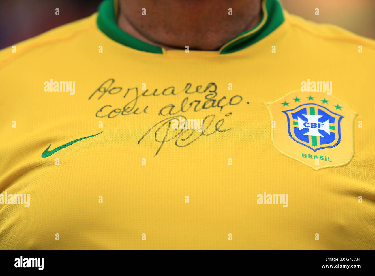 A Brazilian fan wearing a national team shirt signed by Pele, before ...