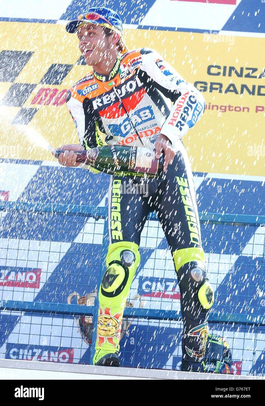 Italian Honda rider Valentino Rossi celebrates with the trophy after ...