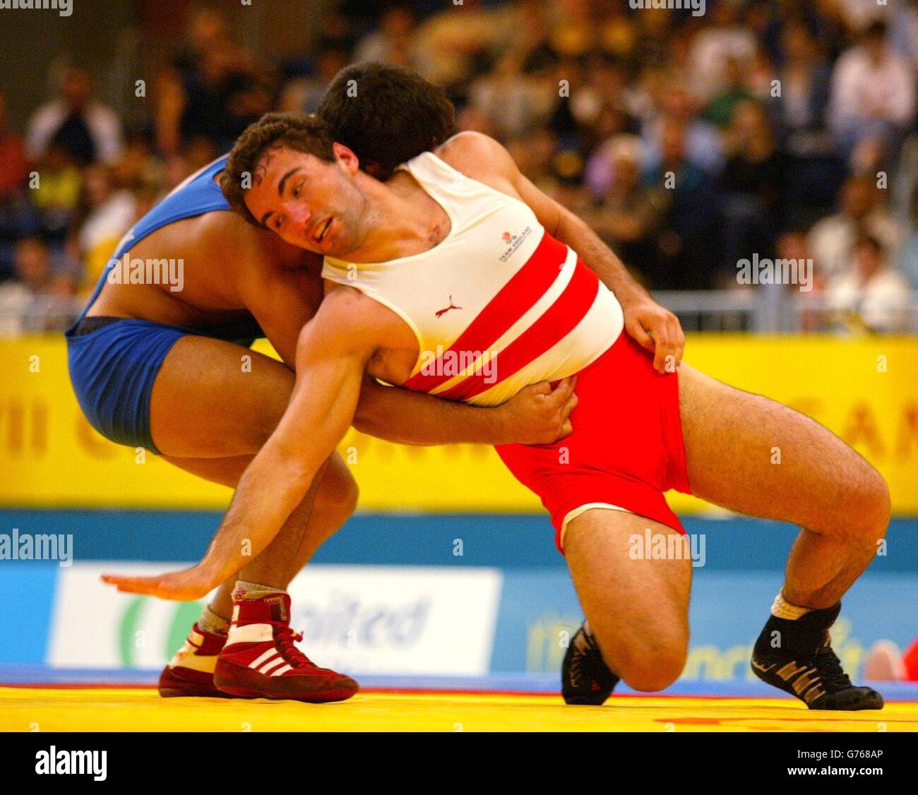 English wrestler Nate Ackerman grapples with Pakistan's Muhammad Ali in the Mens 74kg wrestling ...