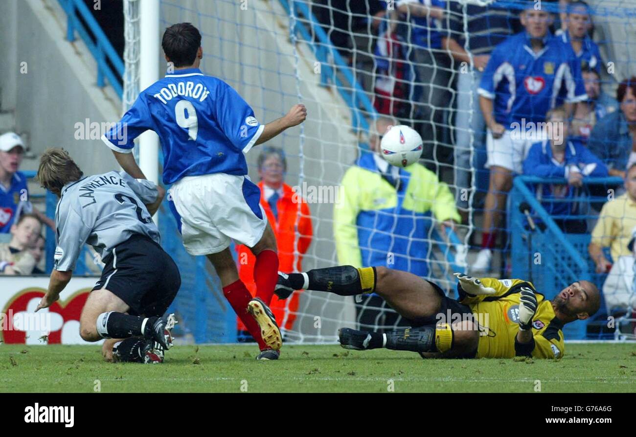 Portsmouth's Svetoslav Todorov splits Matt Lawrence and goalkeeper Tony ...