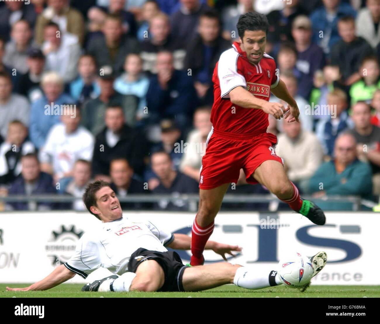 Derby's Chris Riggott (left) tackles Walsall's Jorge Leitao, during ...