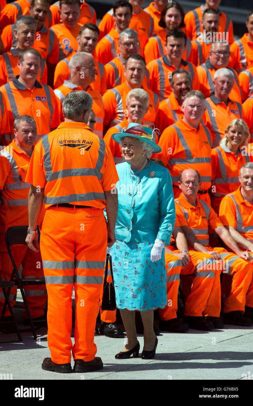 Queen elizabeth ii poses for a team photograph as she officially opens ...