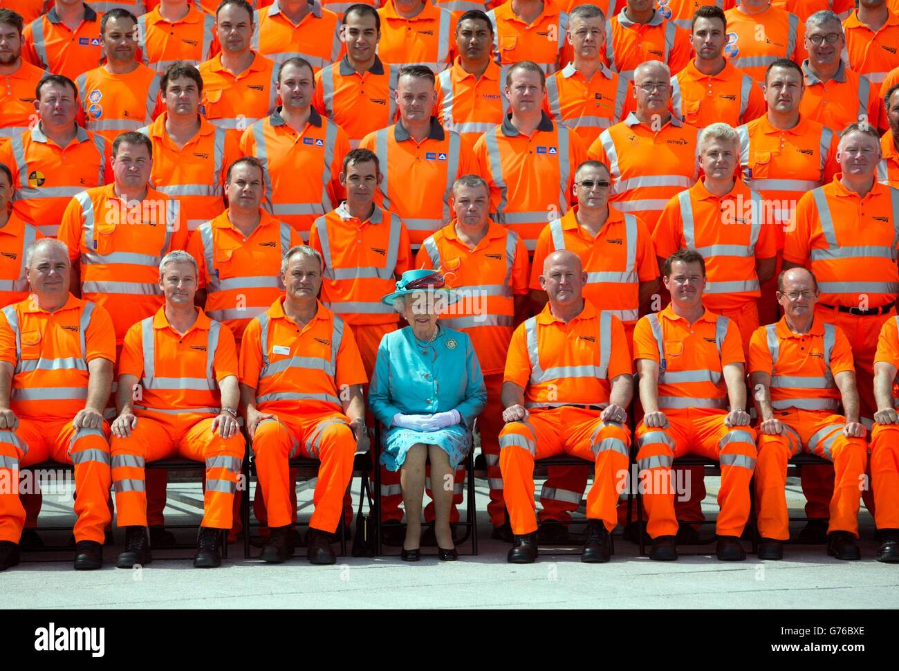 Queen elizabeth ii poses for a team photograph as she officially opens ...