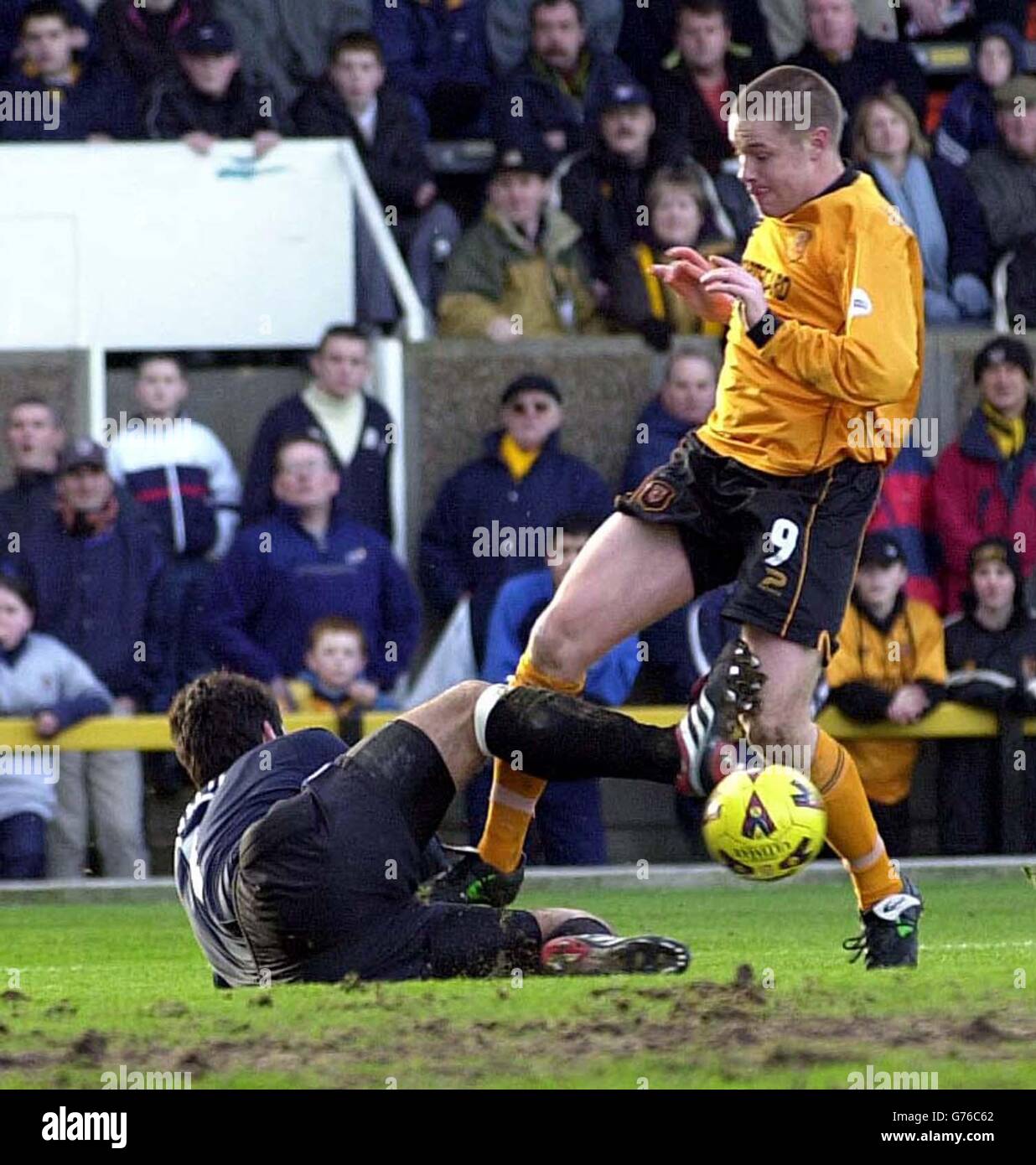 Rushden and Diamonds' goal keeper Billy Turley dives at the feet of ...