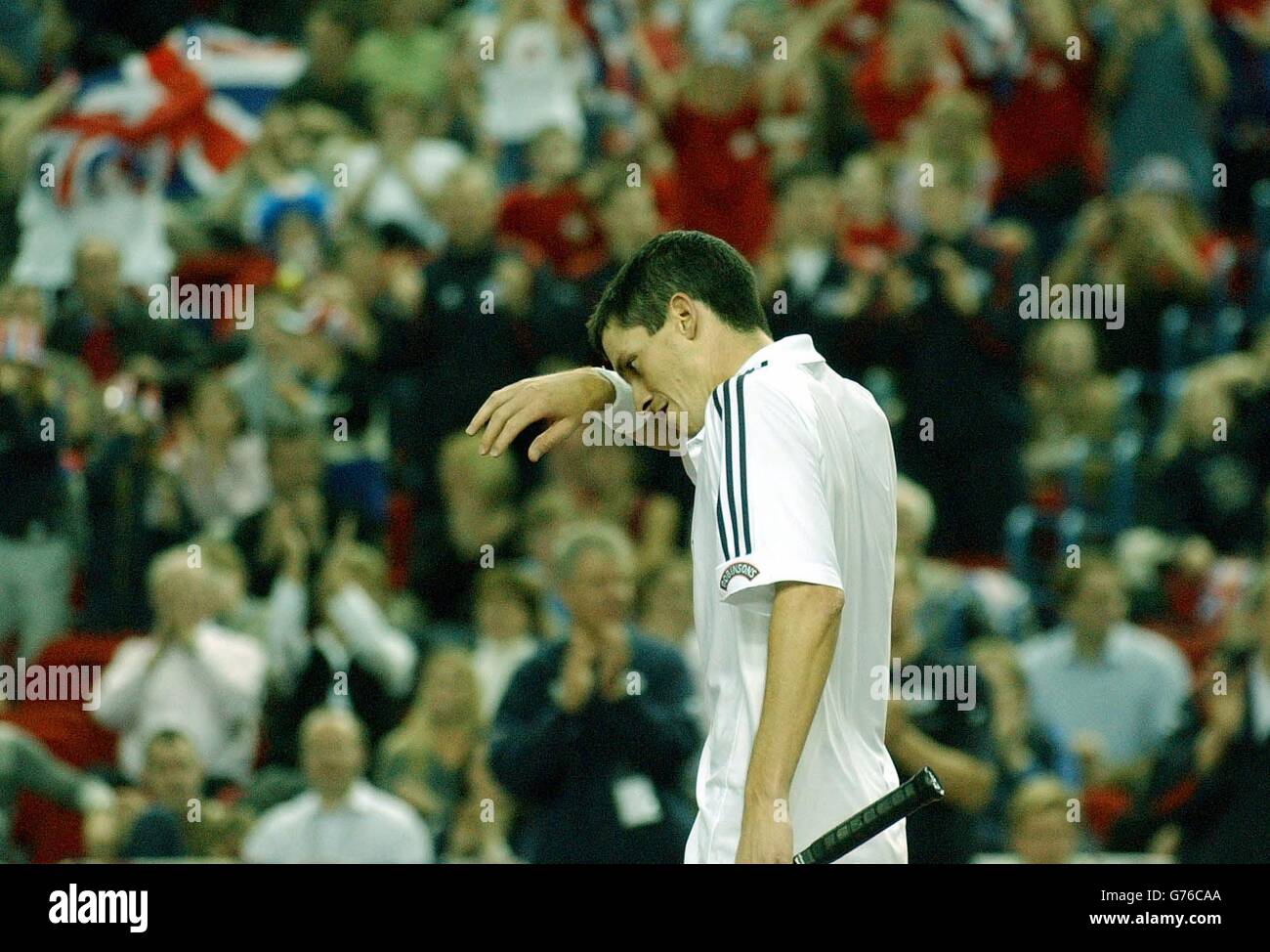 Tim Henman shows the strain as the crowd try to lift him afte his ...
