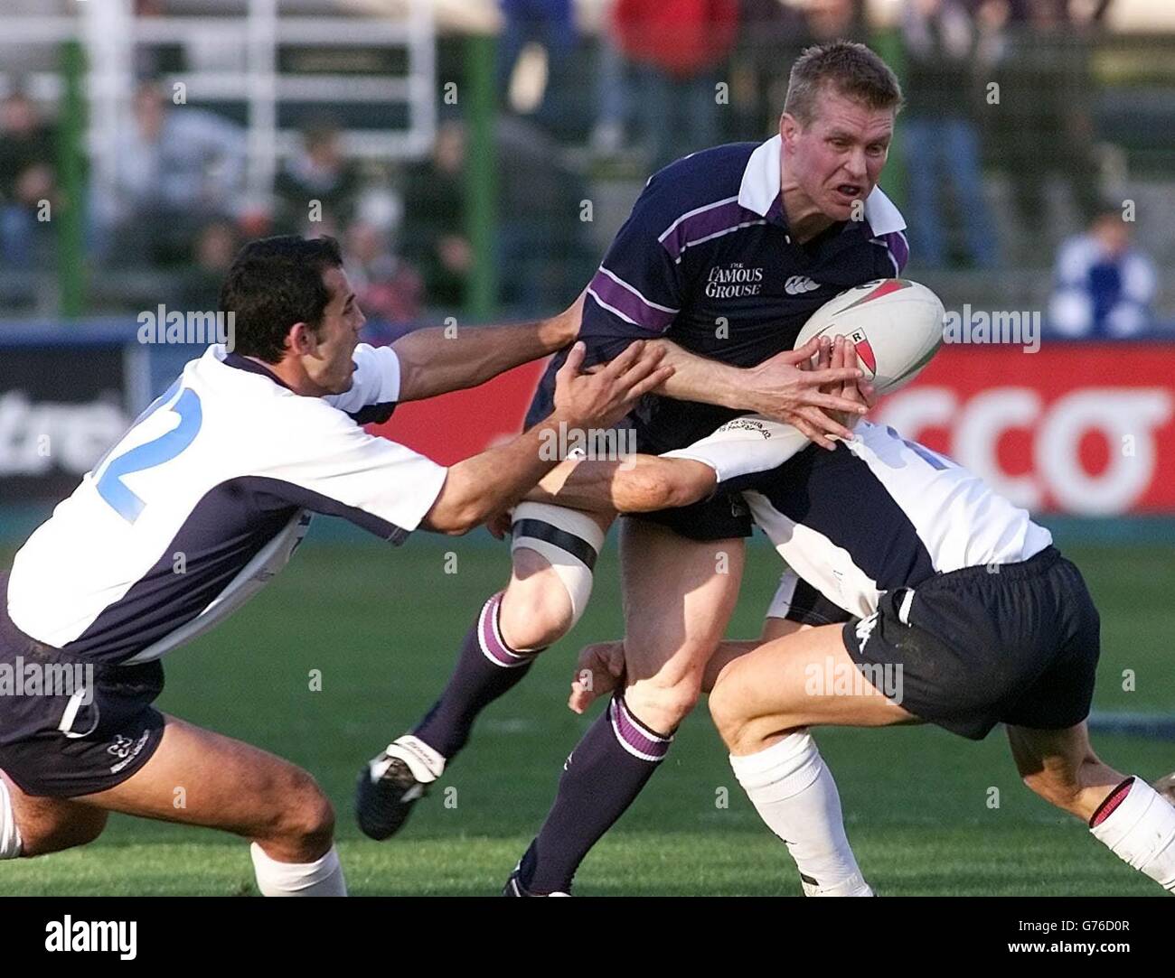 Italy's Luca Martin (left) and Diego Dominguez try to stop Scotland's ...