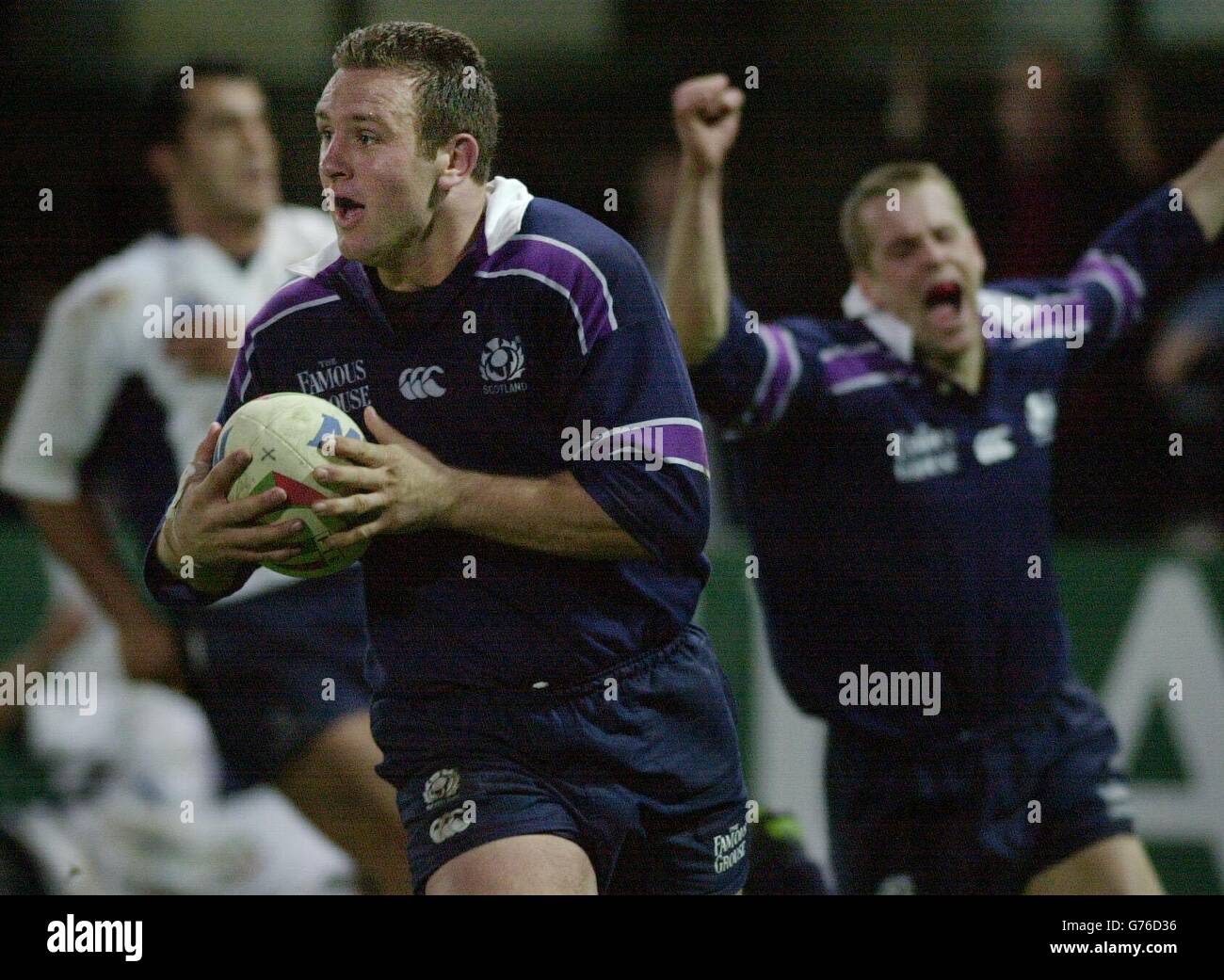 Brendan Laney of Scotland, bursts through Italian lines to score a ...