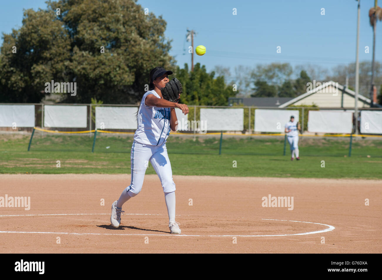 High school softball player throwing the ball on defense Stock Photo ...