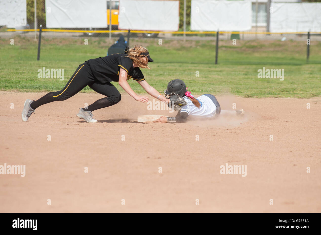 High school softball player tagging the sliding runner Stock Photo - Alamy