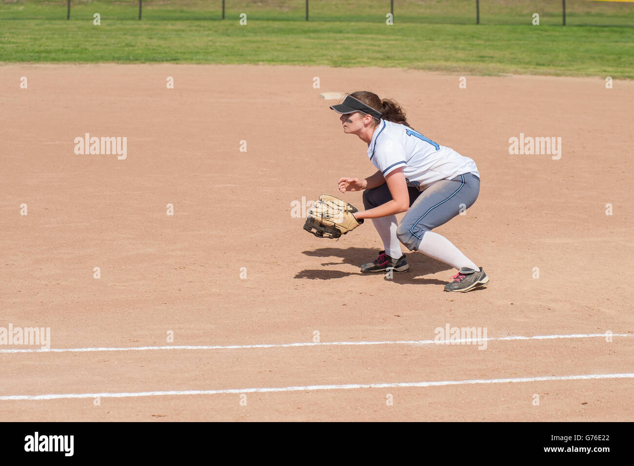 High school softball player crouched and ready on defense Stock Photo ...
