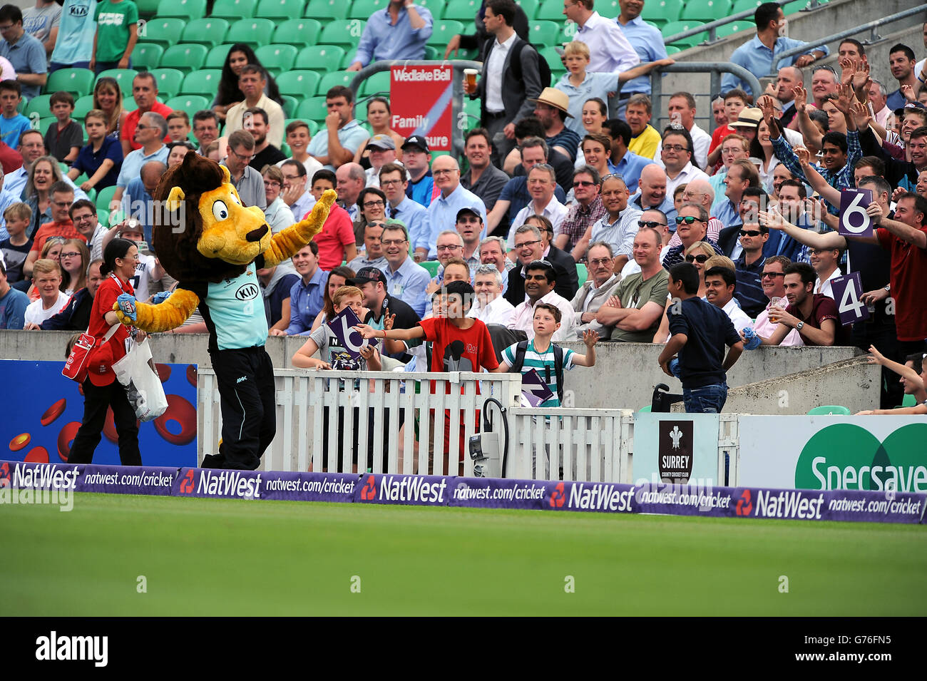 Surrey mascot Caesar the Lion throws t-shirts to the young fans in the ...