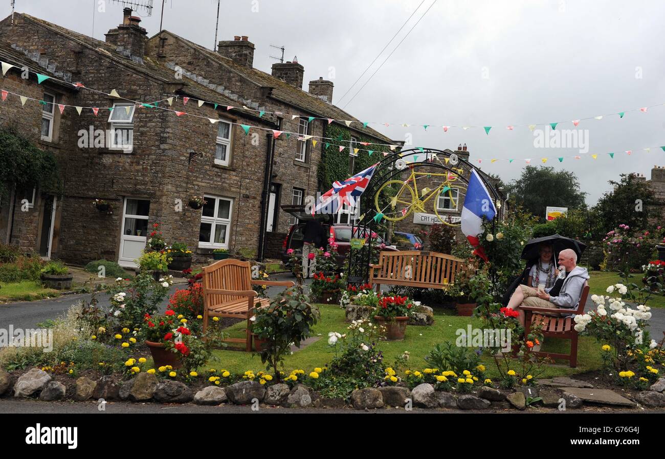 A couple enjoy some tea in the rain on the Tour De France route in ...