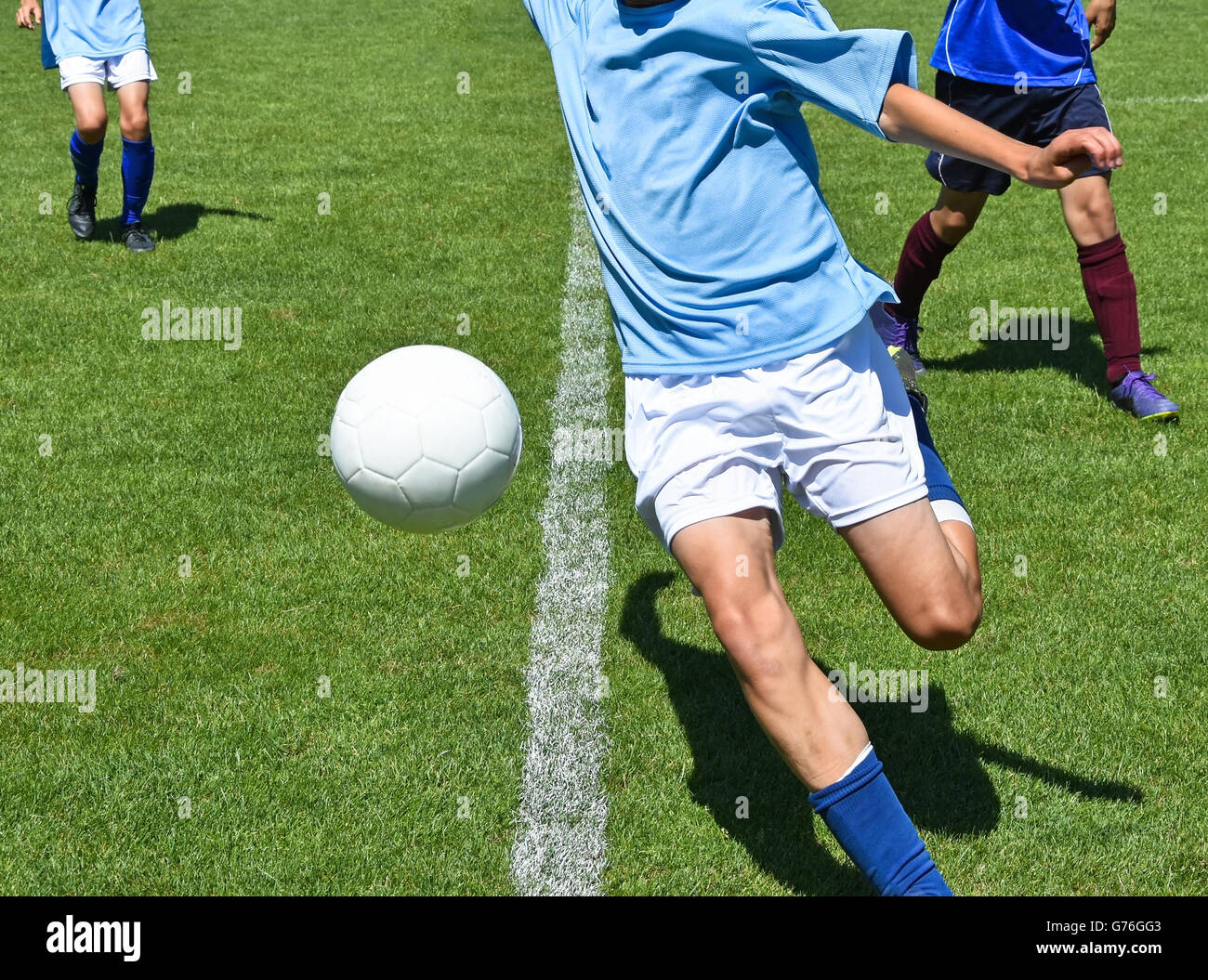 Young soccer players in action Stock Photo - Alamy