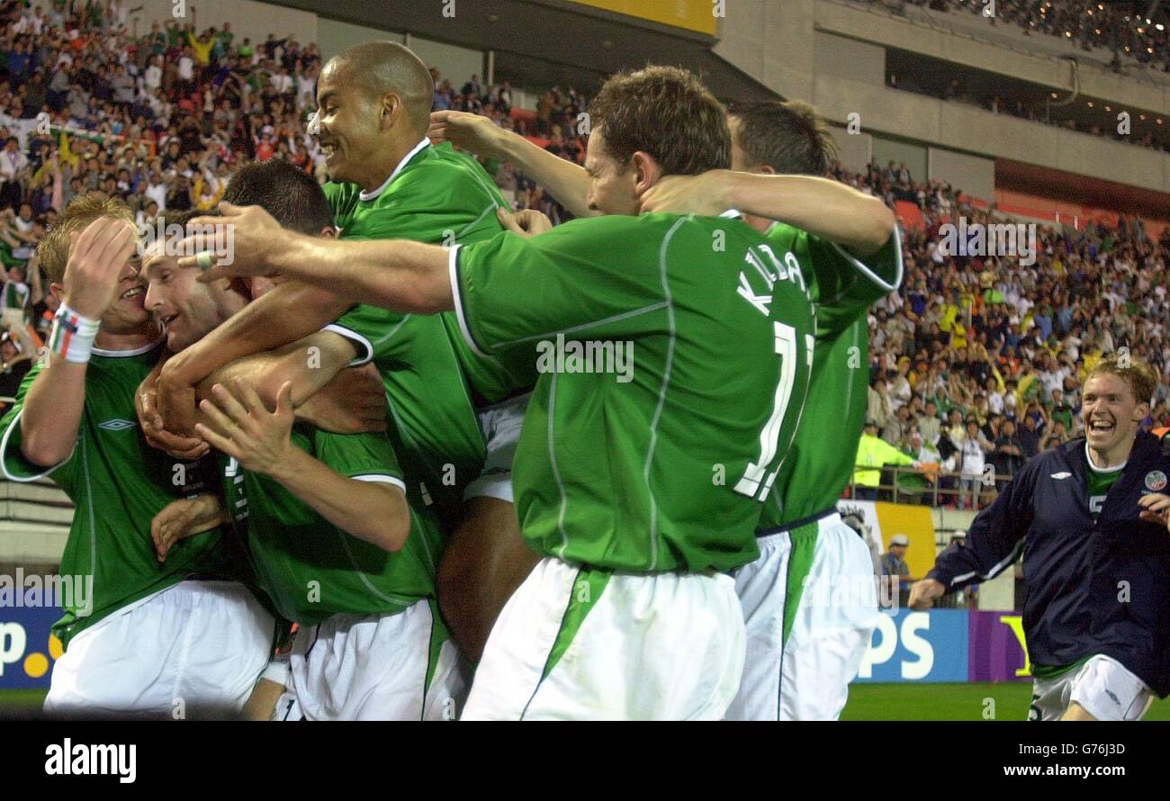 Republic of Ireland striker robbie Keane is mobbed by Irish team-mates ...