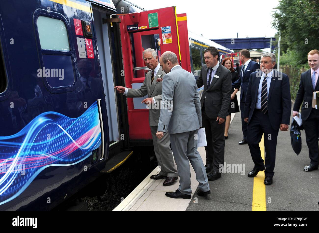 The Prince of Wales makes his way on board a train to London Paddington ...