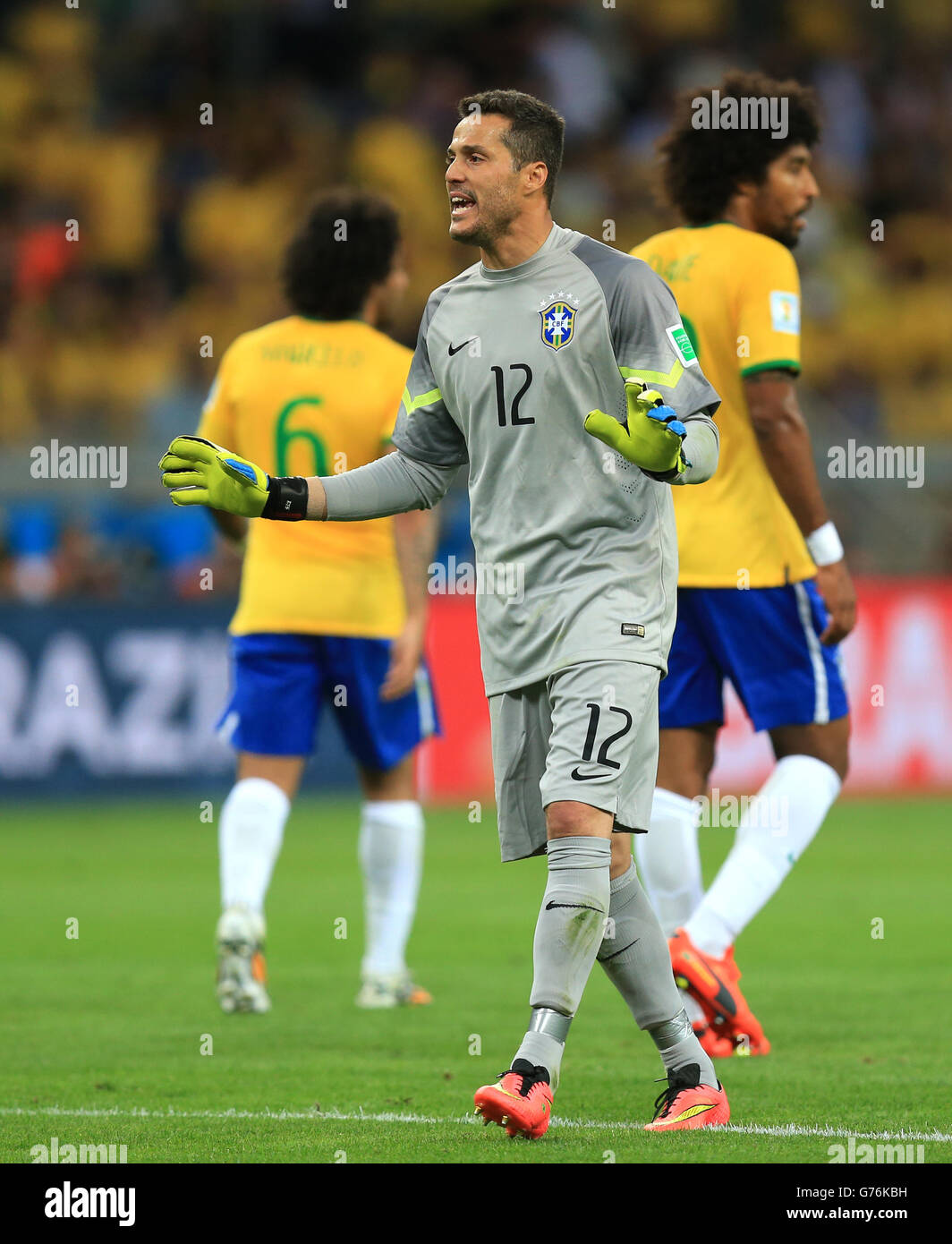 Brazil goalkeeper Julio Cesar attempts to encourage his teammates ...