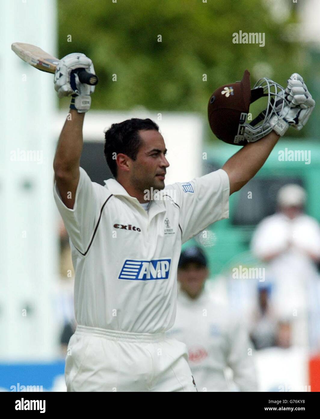 Surrey Cricket Captain, Adam Hollioake, raises his bat to celebrate his ...
