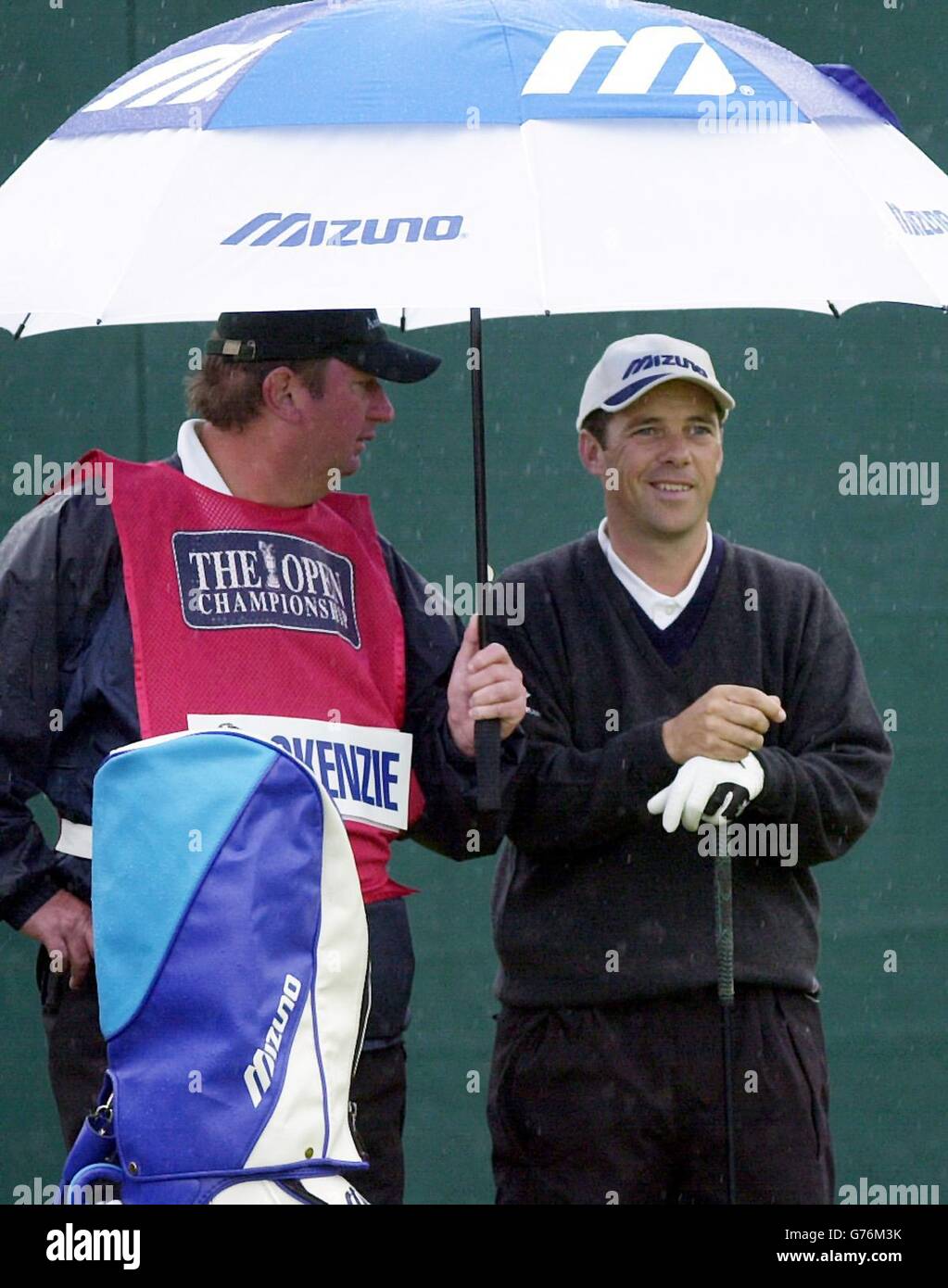 England's Malcolm Mackenzie (right) and his caddie shelter from the ...
