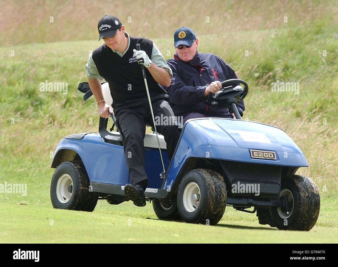 Scotland's Paul Lawrie gets a lift back from the rules referee after ...