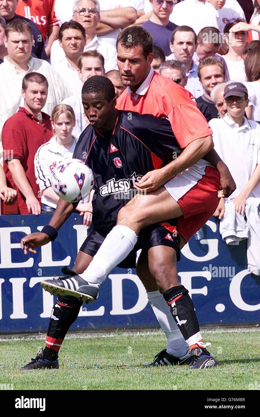 Charlton player Kevin Lisbie (right) tangles with Welling player ...
