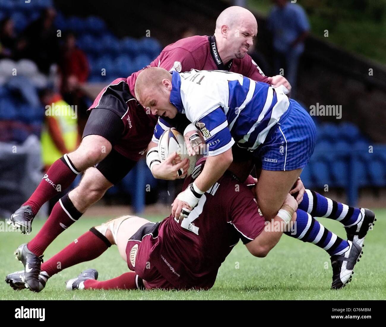 Leeds Rhinos's Adrian Vowles (top) and Matt Adamson tackle Halifax Blue ...