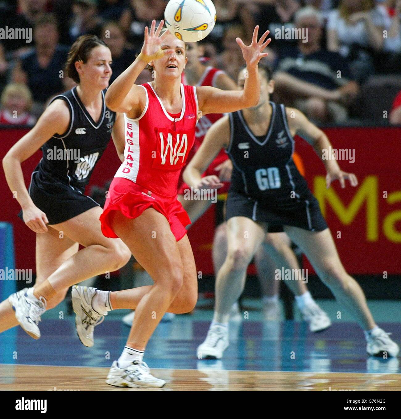 England's Tracey Neville recieves a pass infront of New Zealand's ...