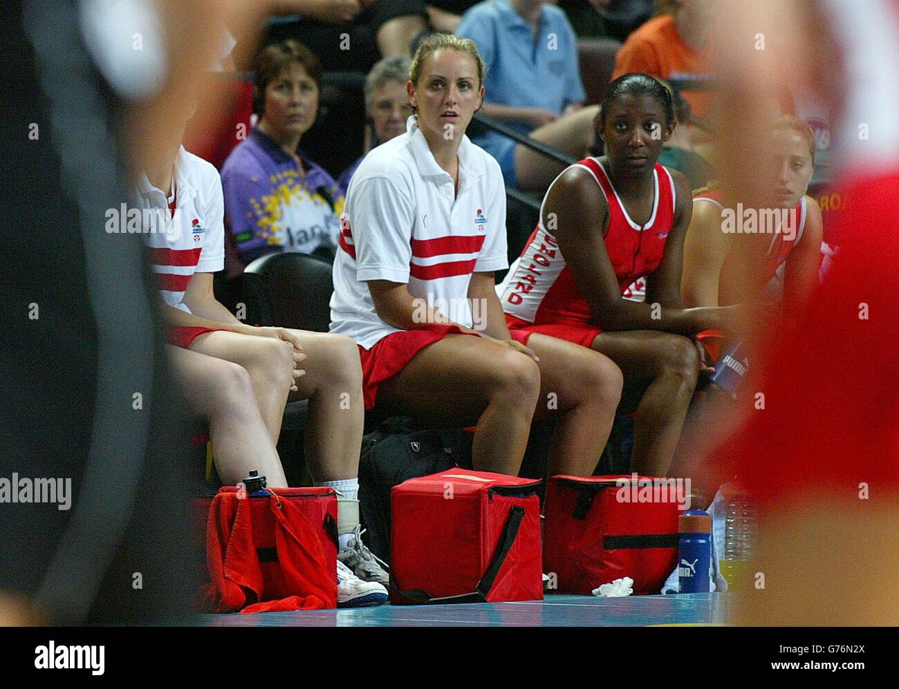 England's Tracey Neville (centre) watches the game from the bench ...