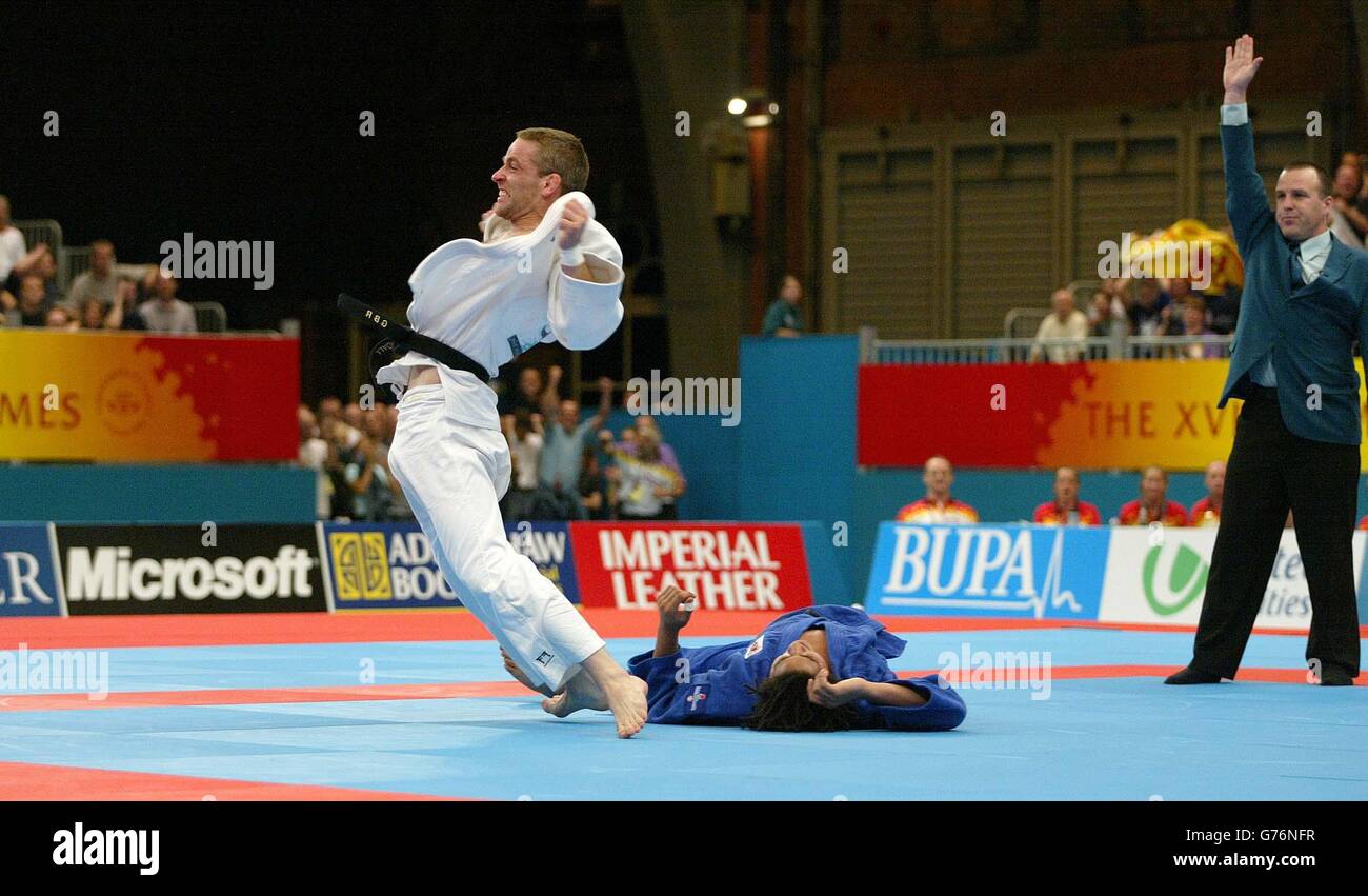 Scotland's Graeme Randall (white) throws England's Thomas Cousins to ...