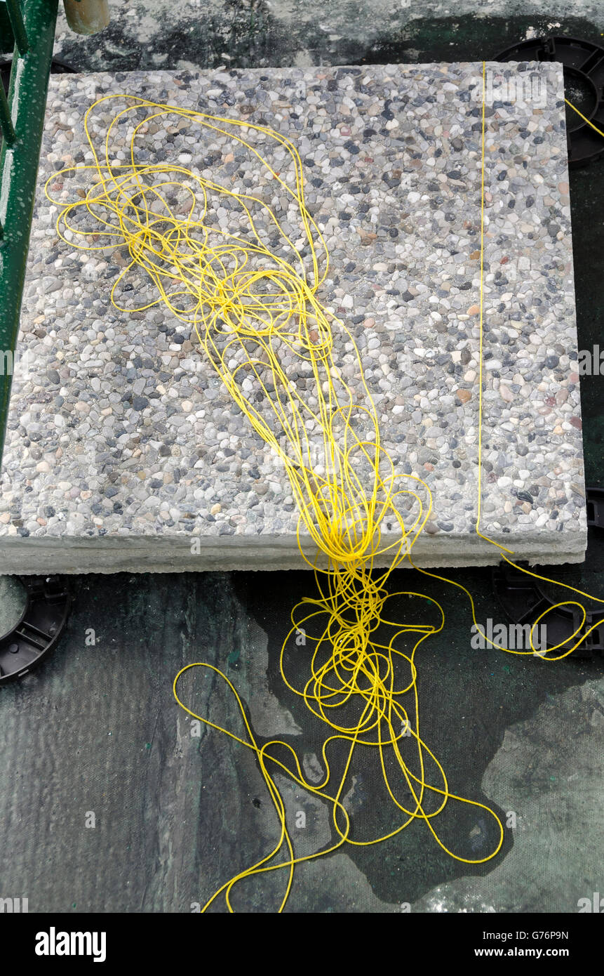 Floating tile on a building site with thread for alignment Stock Photo ...