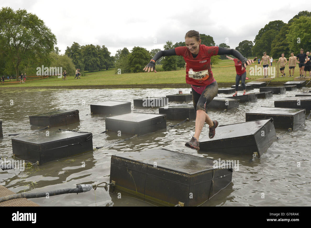 Competitors cross water obstacles during the Tough Mudder Midlands ...