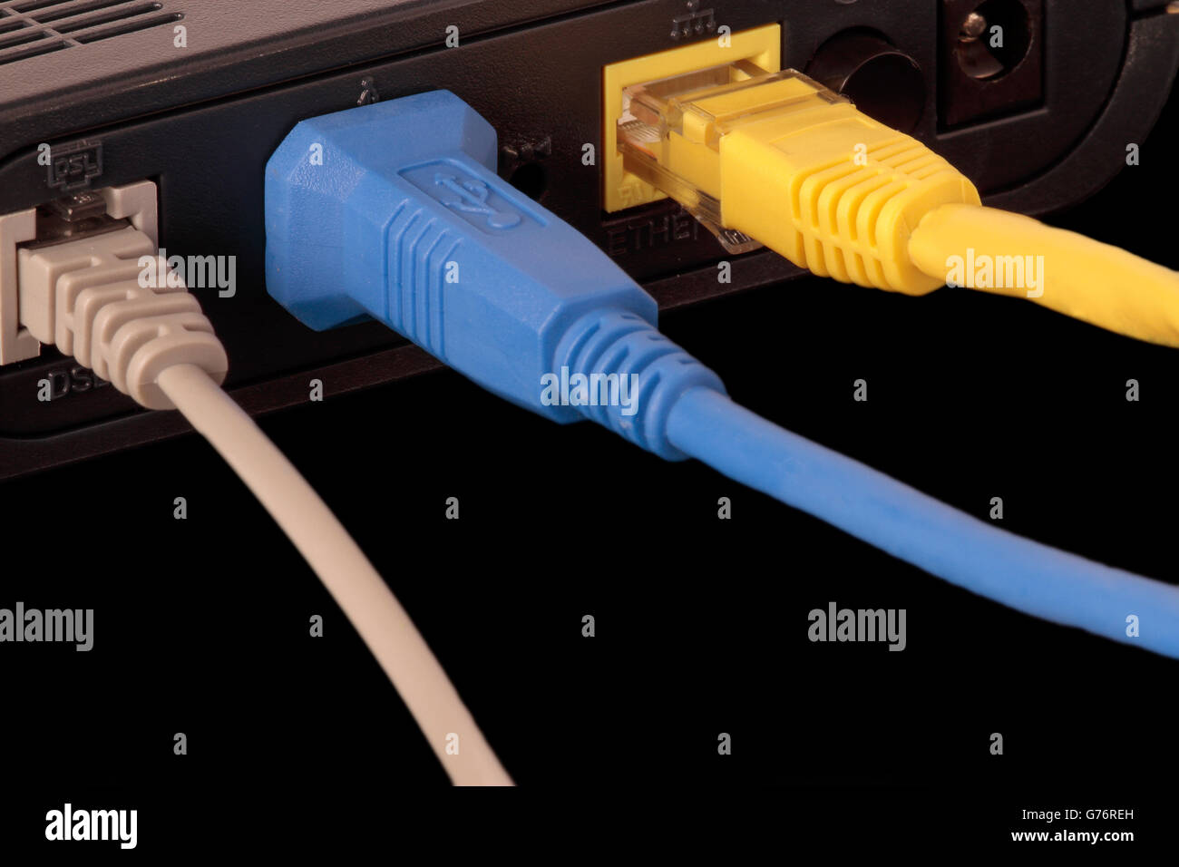 foreground of the back of a router with a rj45, a usb cable and a ...