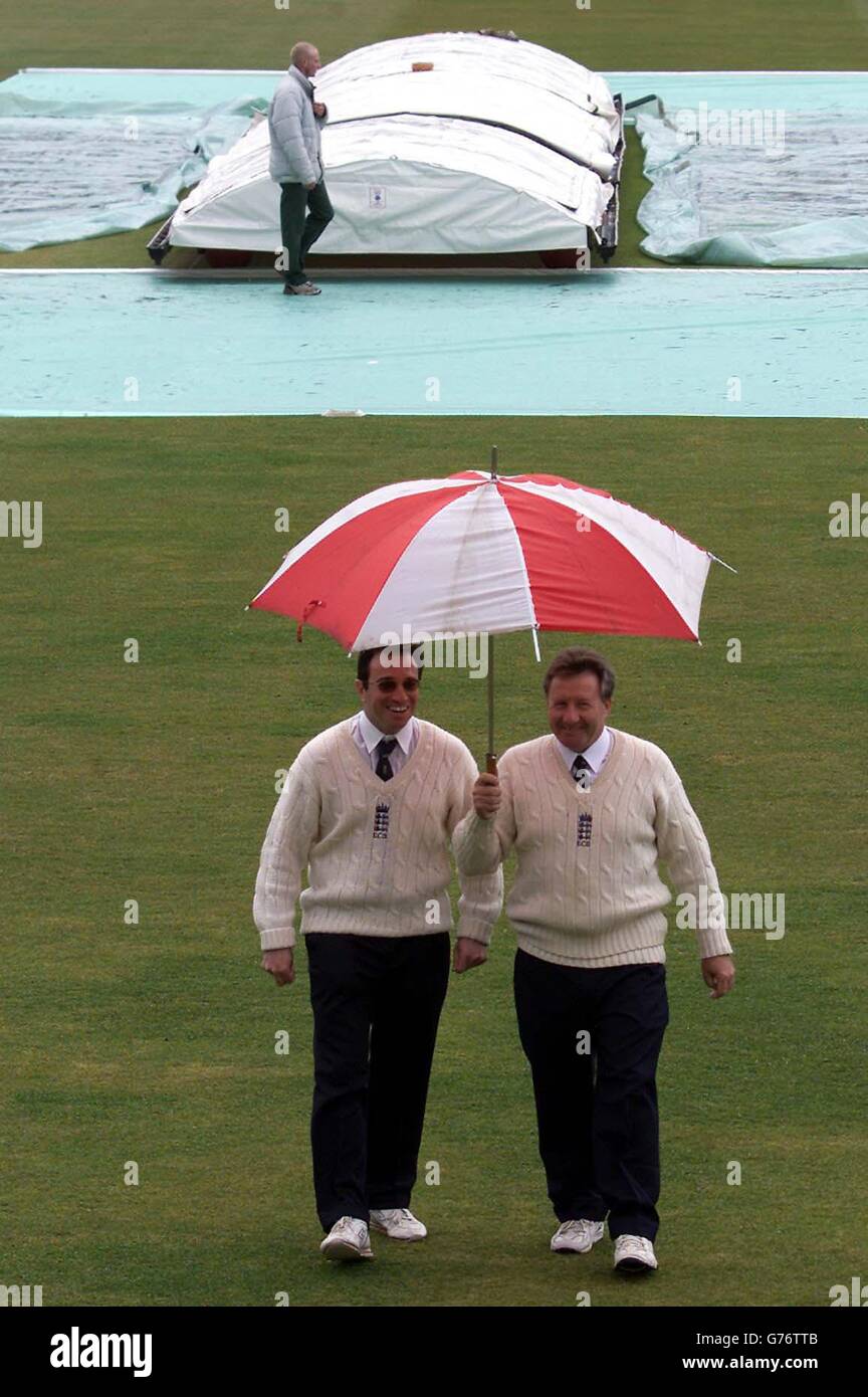 Umpires Neil Bainton, left and Nigel Cowley inspect the pitch at ...