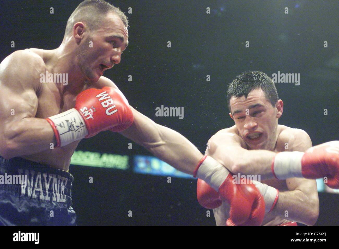 Colin Dunne (right) exchanges punches with Wayne Rigby during their IBO ...