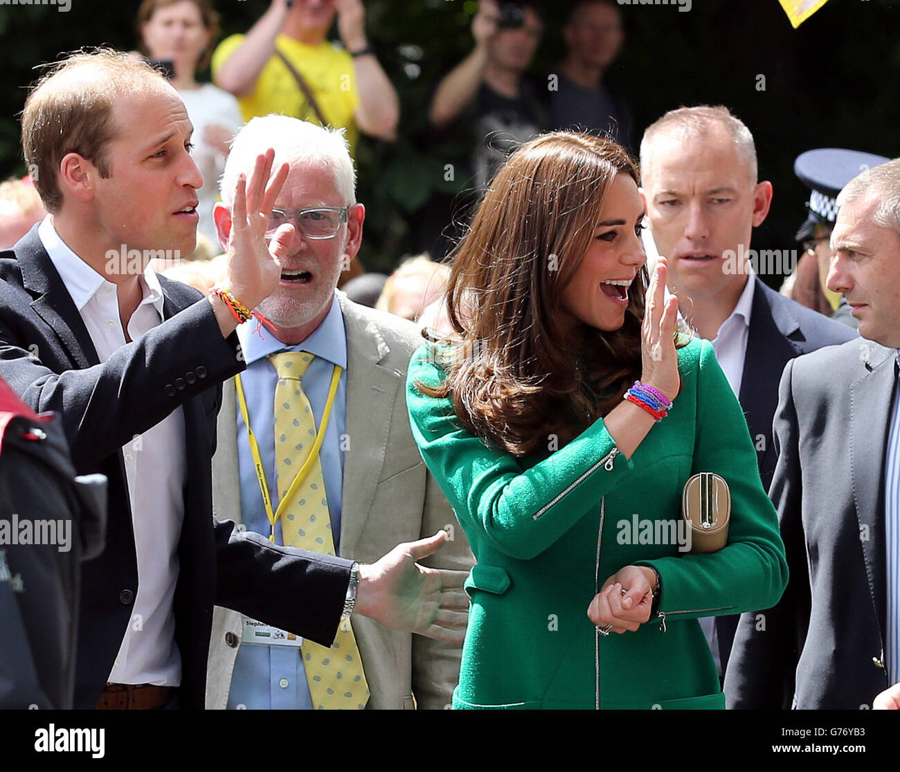 The Duke and Duchess of Cambridge wave to the crowds gathered to ...
