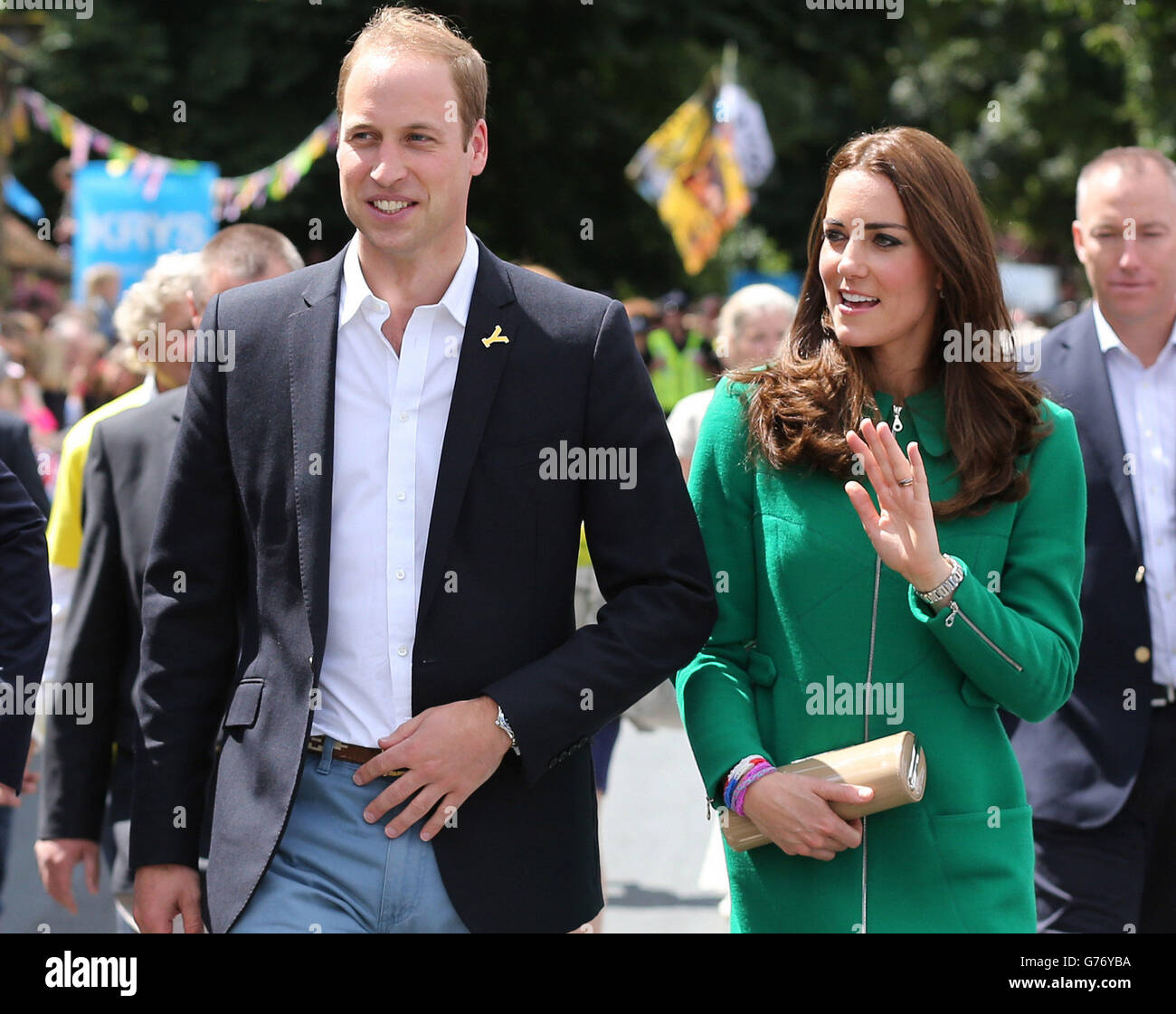 The Duke and Duchess of Cambridge wave to the crowds gathered to ...
