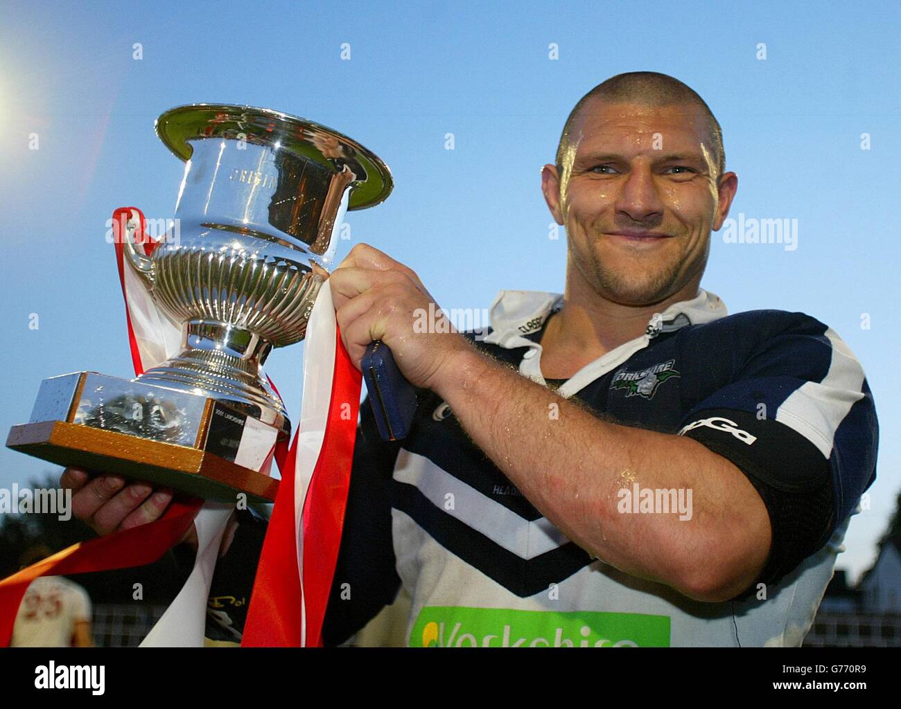 Lancashire captain Barrie McDermott (Leeds) holds the Origin trophy ...
