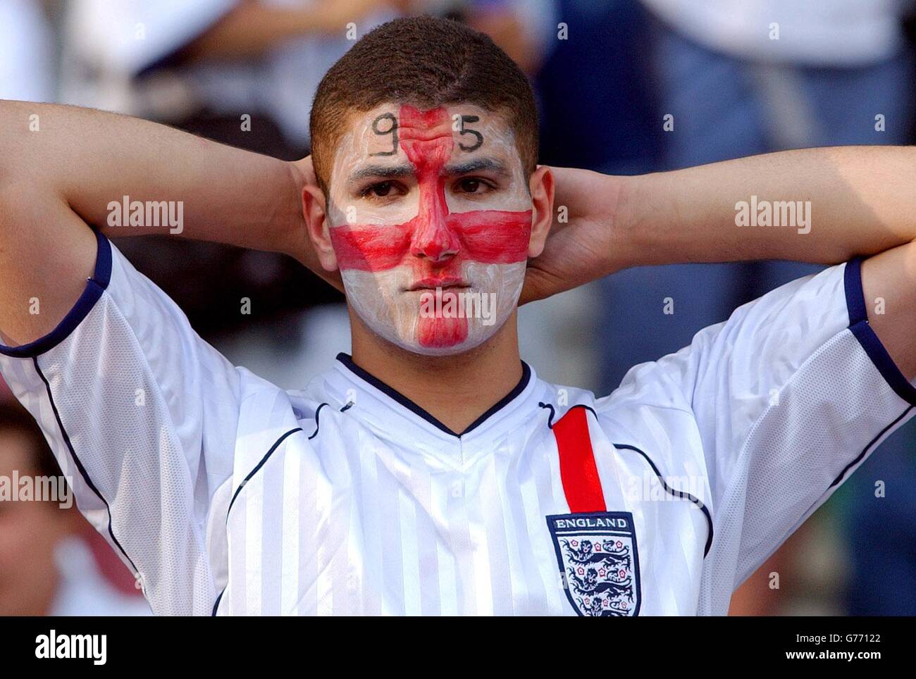An England fan holds his head after watching his side lose their ...