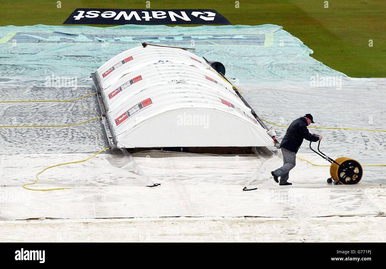 Groundstaff at work on a covered Headingley pitch before the start of ...