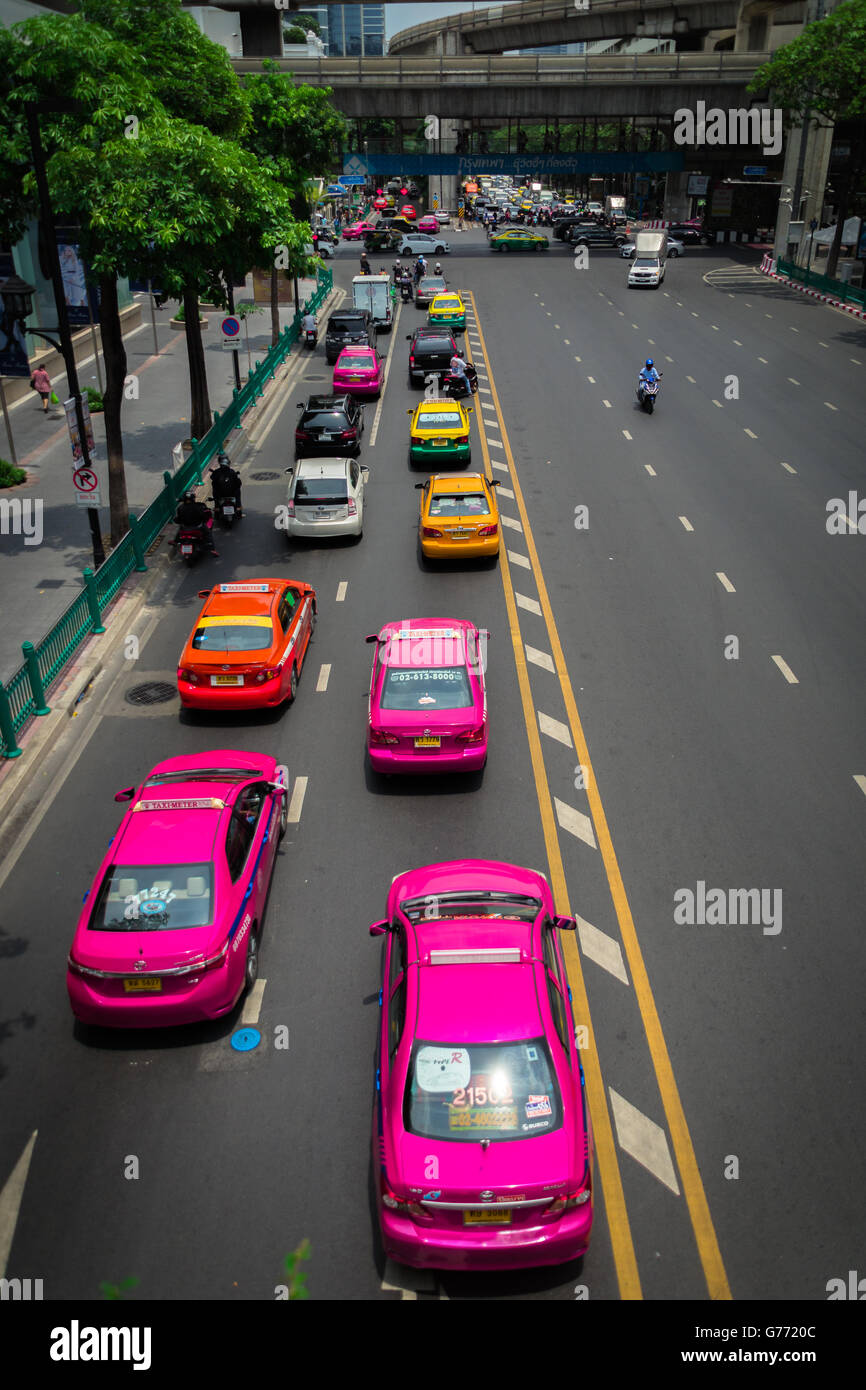Colorful pink, yellow taxis in the traffic of Bangkok Stock Photo - Alamy