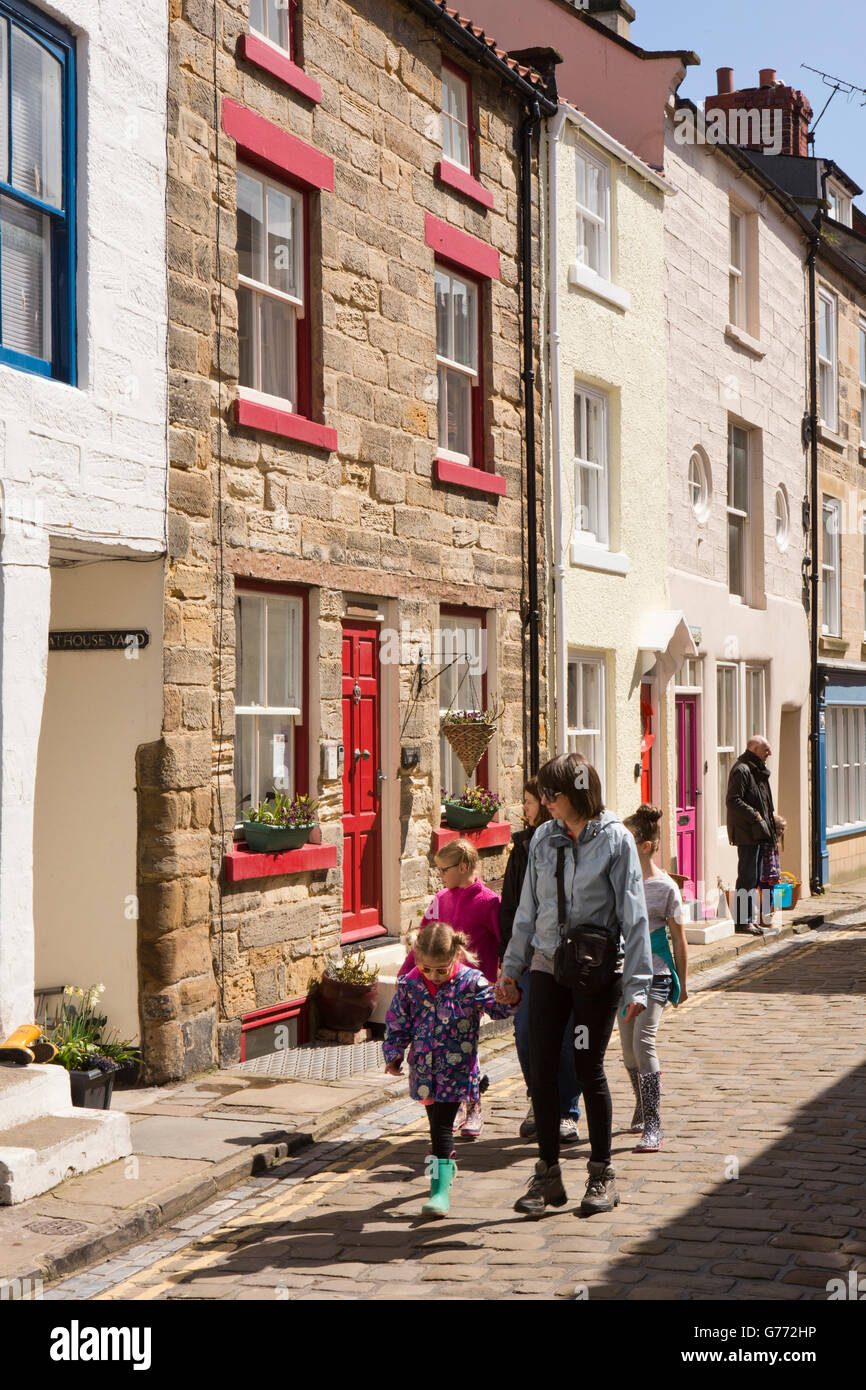 UK, England, Yorkshire, Staithes, High Street, family walking on ...