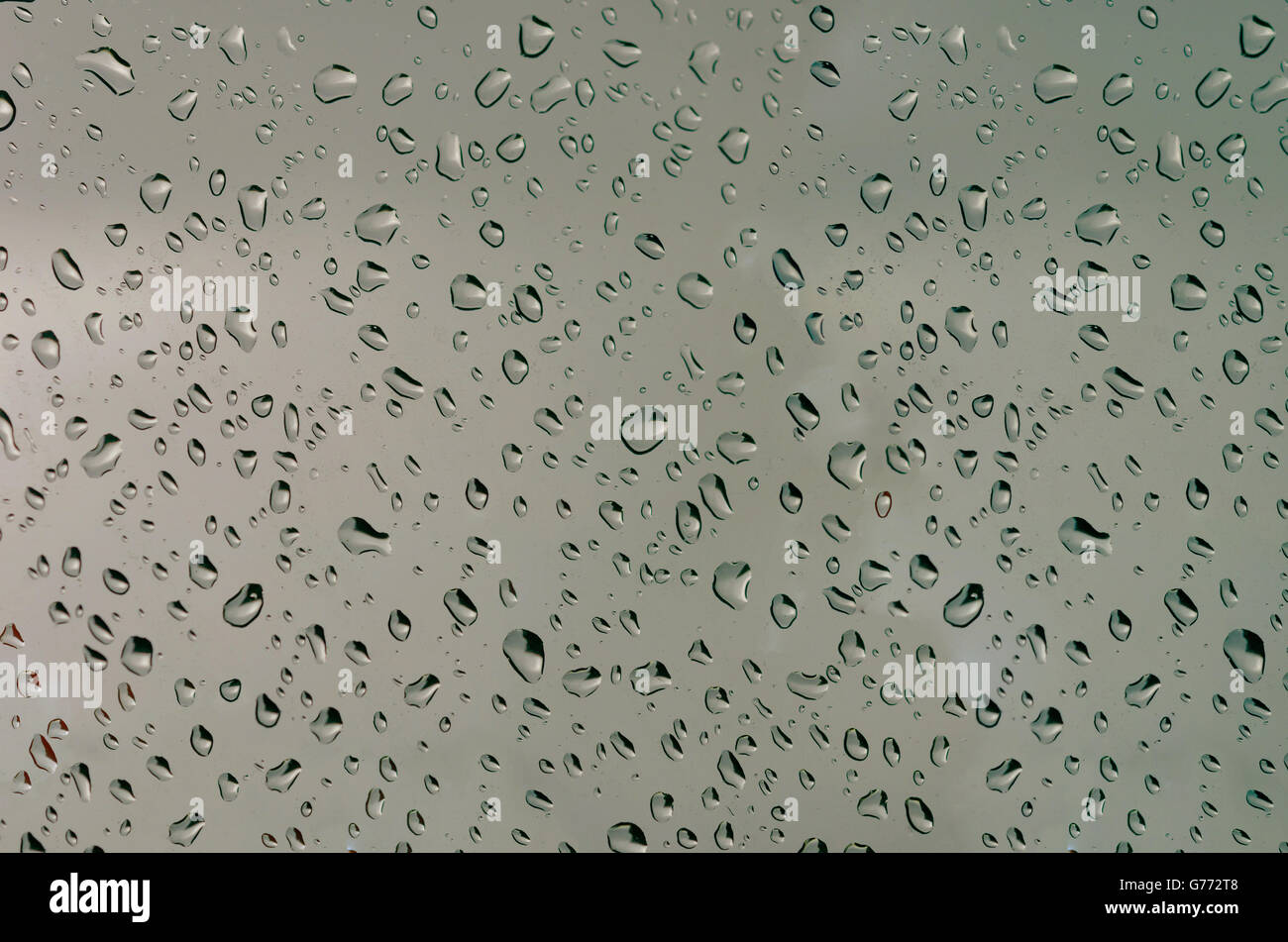 Water droplets on the glass with a colored background. Drops of water ...