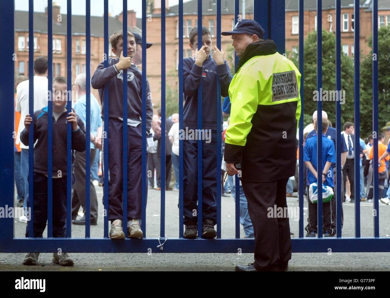 Young fans appeal to a security guard to be let in as the game is ...