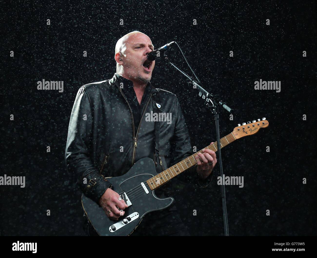 Baz Warne from The Stranglers performing in the rain on the Main Stage ...